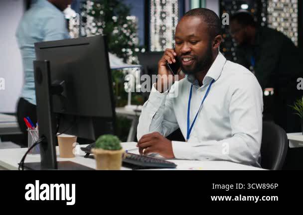 African american business analyst making a phone call late at night to ...