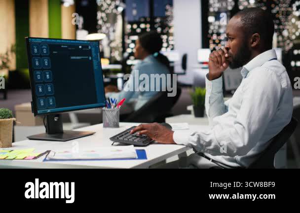 Young man PC user interacting with AI chat system on pc at office late ...