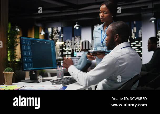 Black IT engineers team developing app and software algorithm on pc ...