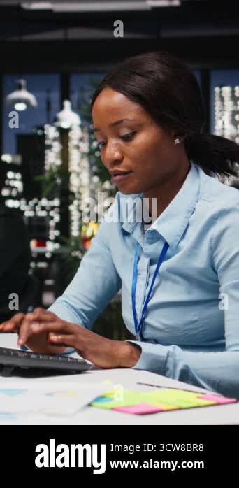 Vertical Video African american person focused on proofreading project ...