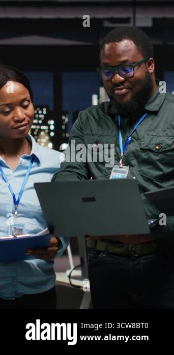 Vertical Video Portrait of associates group reviewing data numbers on ...