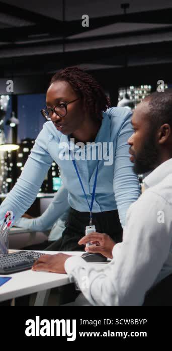 Vertical Video African american staff members use AI chatbot system at ...