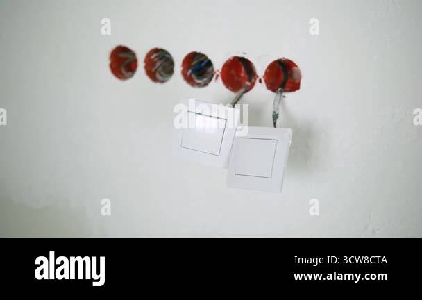 White switches and wiring boxes on a plaster wall, construction ...