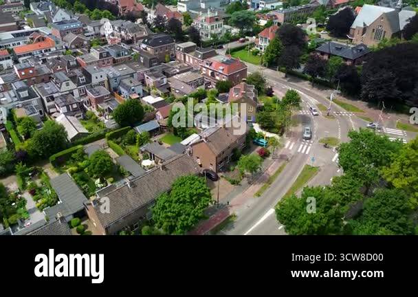 Aerial view of suburban neighborhood with roundabout, sloped roof ...
