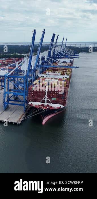 Aerial view of a large container cargo ship is beeing loaded in a ...