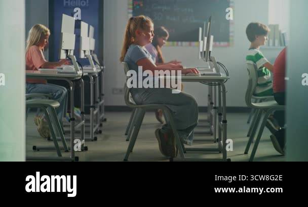Schoolchildren Study on Computers in Sunshine Classroom. Blonde ...