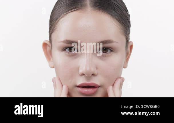 Young woman touching smooth glowing face skin Stock Video Footage - Alamy