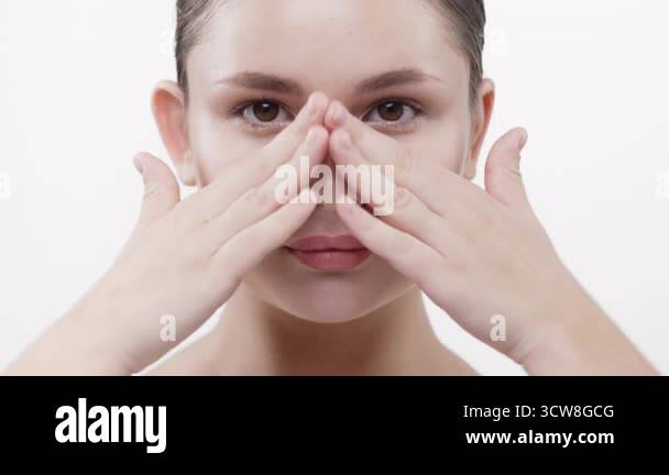 Woman touching nose gently using both hands Stock Video Footage - Alamy