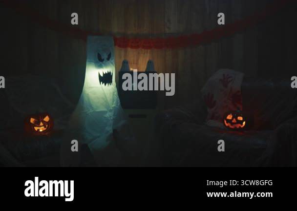 A tall ghost lamp with an angry face and sharp teeth glows, surrounded ...