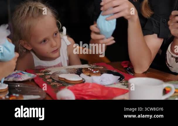 A female pastry chef teaches children how to decorate Christmas ...