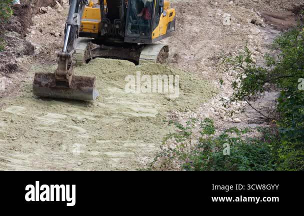 LVIV, UKRAINE - AUGUST 10, 2025: An excavator is performing excavation ...