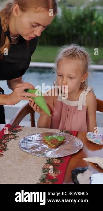 A female pastry chef teaches children how to decorate Christmas ...