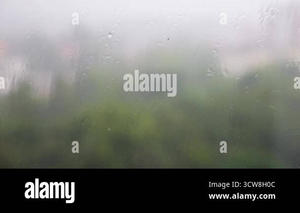 Raindrops fall on a windowsill during a rain. Raindrops on glass Stock ...