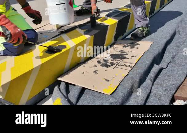 Coating safety stripes on railway platforms. Coating railway platforms ...