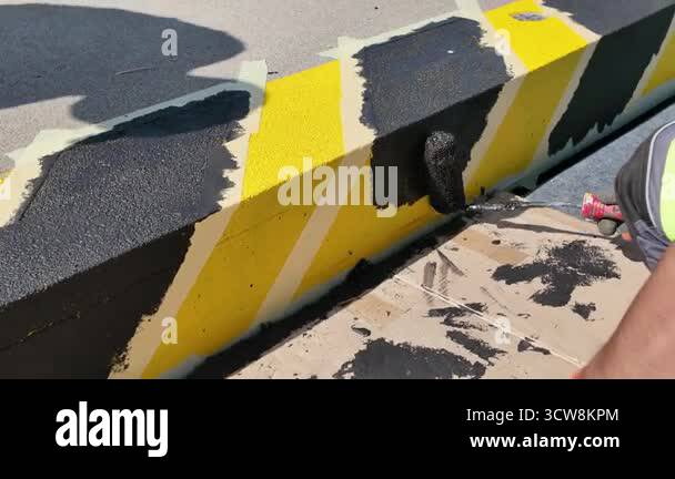 Coating safety stripes on railway platforms. Coating railway platforms ...
