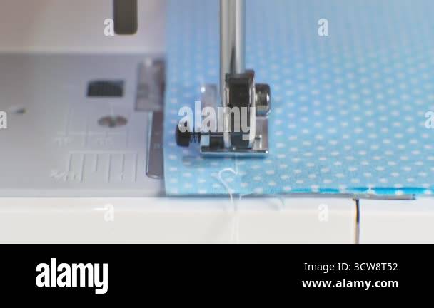 Video sewing machine steel needle holder stitching with thread on blue ...