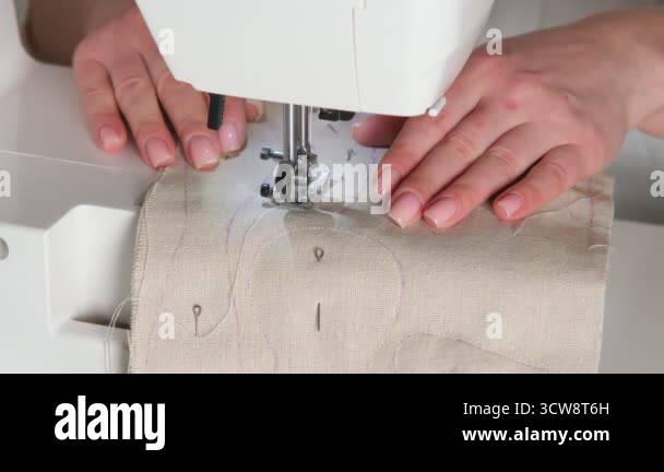 Video animation of cropped woman hands sewing and stitching on template ...