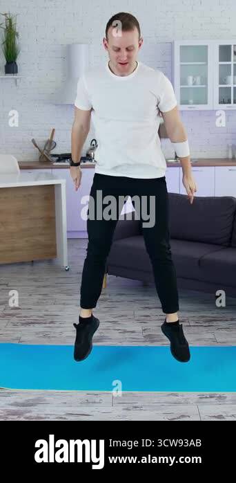 Quarantine man doing exercise indoor. Lifestyle strong man training his ...