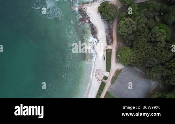 Aerial drone view of a rocky sunset beach coastline in Lanterna ...