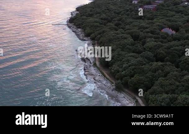 Aerial drone view of a rocky sunset beach coastline in Lanterna ...