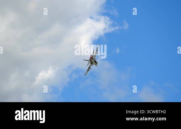 Slow motion close up view of F18 fighter jets flying beneath the clouds ...