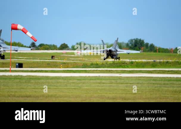 Slow motion close up rear view of two F-18 fighter jets taxi on the ...