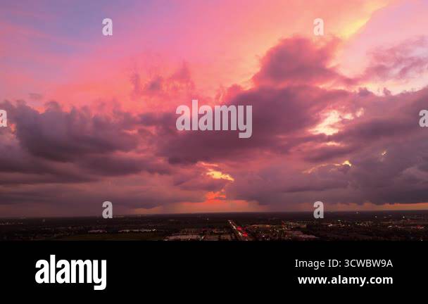 Colorful dramatic sky with golden rose purple layered clouds at sunset ...