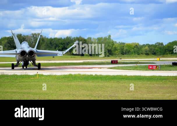 Slow motion rear view of F-18 fighter jets heading to takeoff runway ...