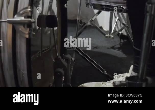 Man playing base drum pedal on stage. Close-up, Drummer playing drums ...