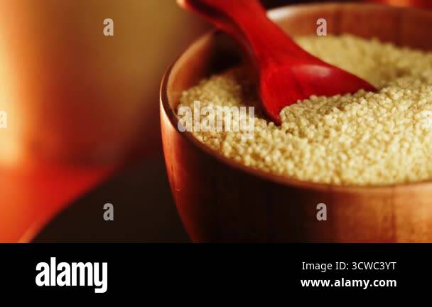 Preparing uncooked couscous for flavorful dishes in a cozy kitchen ...