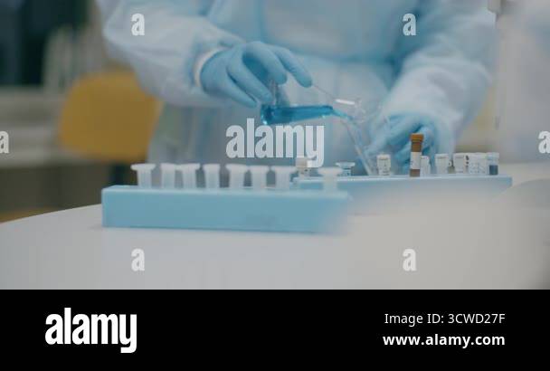 A female scientist performs an experiment in a medical scientific ...