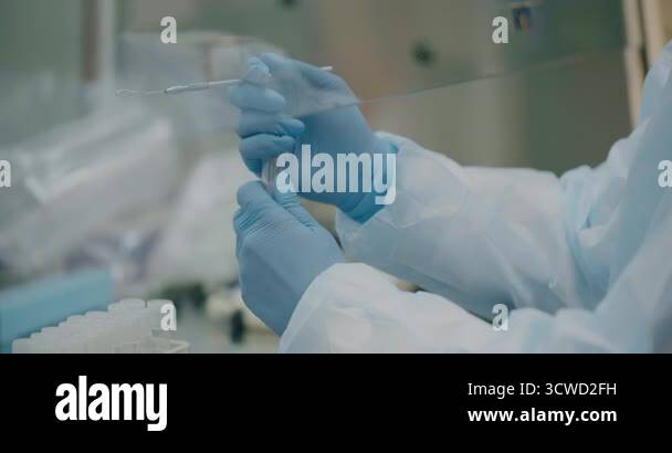 Close-up of a lab technicians hands performing a specialized test ...