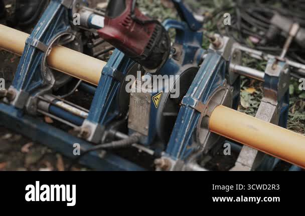 A close-up of the process of facing a plastic gas pipe for welding. The ...