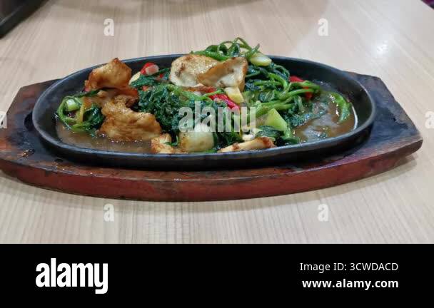 Experience the tantalizing flavors of this stir-fried dish, featuring a ...
