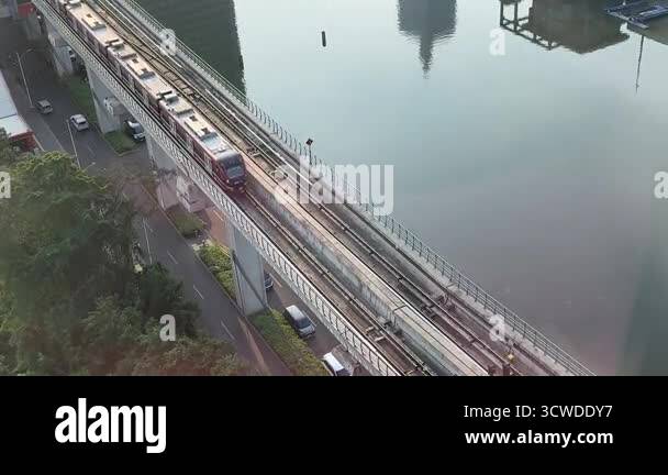 4k footage LRT train monorail going on flyover railway to another ...