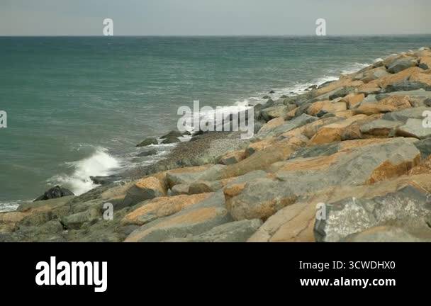 Ocean waves crashing on rocky coastline in storm weather. Soft waves ...