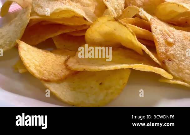 Crispy potato chips, a quick snack. Close-up of spinning potato chips ...