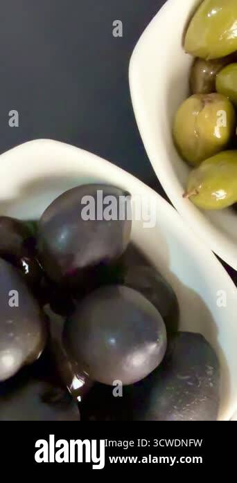 Closeup of green and black olives. Bowls of assorted olives still life ...