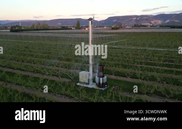 Frost protection fan in agricultural field at cold morning sunrise ...