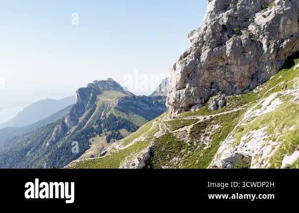 Annecy, France - 10 August 2025: Scenic aerial view of hikers walking ...