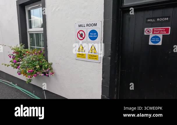 Warning signs outside a mill room in Scotland Stock Video Footage - Alamy