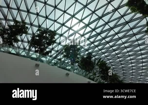 Changi, Singapore - Jul 16 2024: A large building with a glass roof and ...