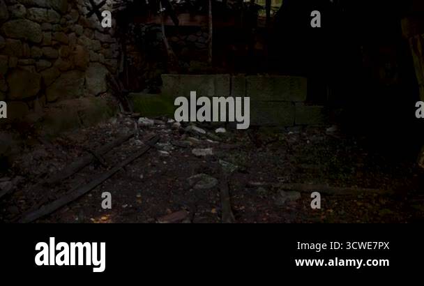 A dilapidated building with a collapsed roof. There are lots of holes ...