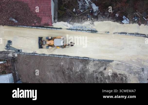 Bulldozer levels sand for road construction. Aerial view of roadwork ...
