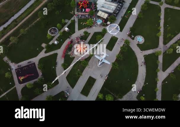 Aerial view of a park with a kite, carousel, airplane, playground, and ...