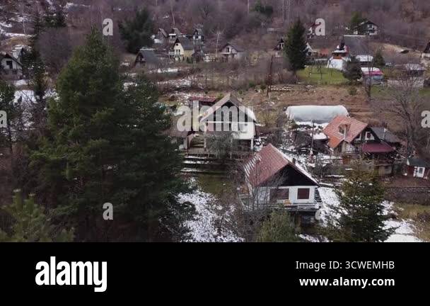 Weekend village houses in a snowy landscape. Cozy cabins and homes ...