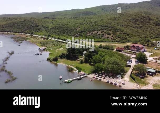 Scenic aerial view of Lake Dojran, showcasing the tranquil waters, lush ...
