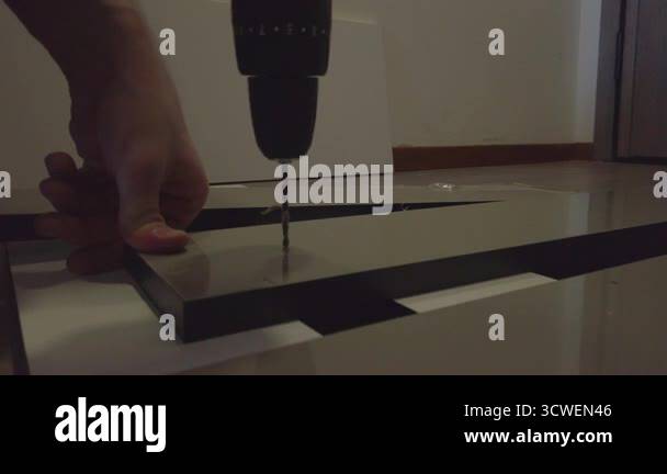 Hand drill making hole in an mdf board. DIY home project Stock Video ...