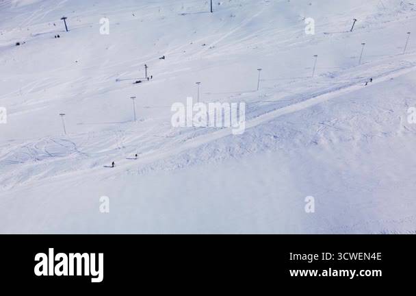 Skiers skiing on slopes in the ski center Popova Shapka in North ...