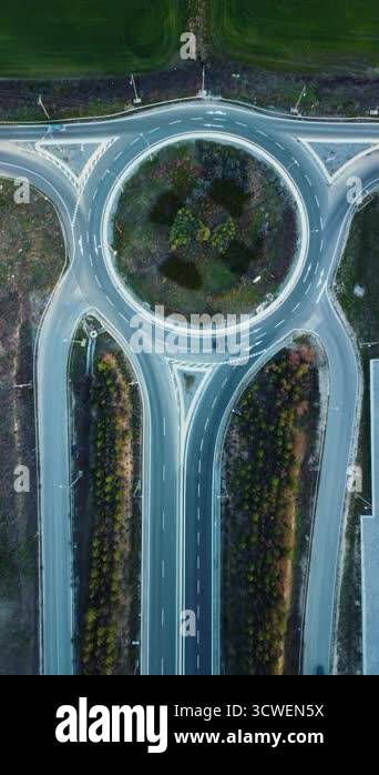 Roundabout traffic circle junction view from above. Vertical aerial ...